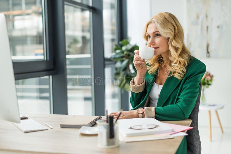 Businesswoman Drinking Coffee and Using Desktop Computer Stock Image ...