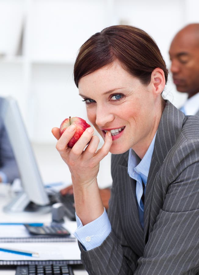 Businesswoman Eating a Fruit at Work Stock Image - Image of hungry ...