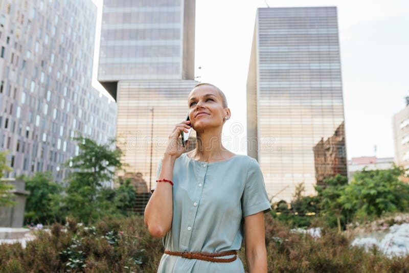 A Businesswoman Engaged in a Phone Conversation Stock Photo - Image of ...