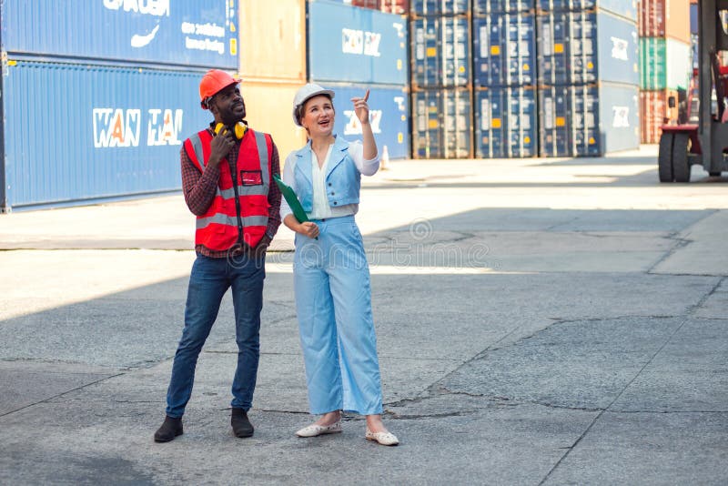 Businesswoman and Engineer Talking and Checking Loading Containers Box ...