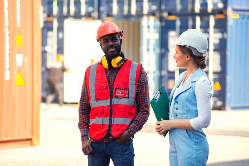 Businesswoman and Engineer Talking and Checking Loading Containers Box ...