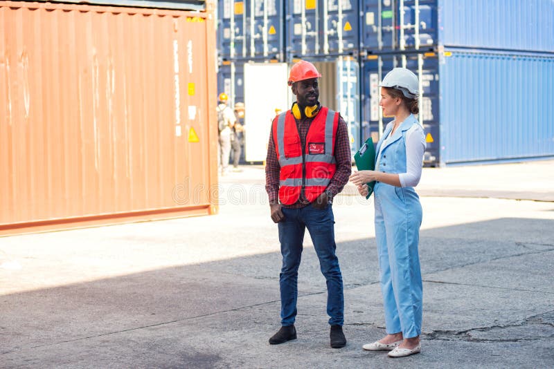 Businesswoman and Engineer Talking and Checking Loading Containers Box ...