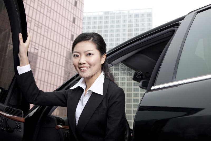 Businesswoman Exiting Car while on the Phone Stock Image - Image of ...