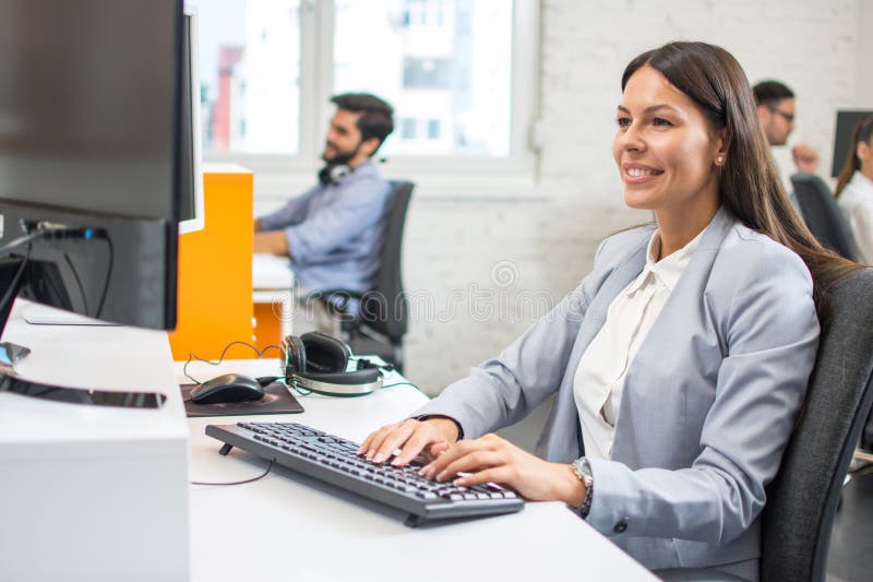 Businesswoman in Formalwear Using Computer at Her Workplace. White ...