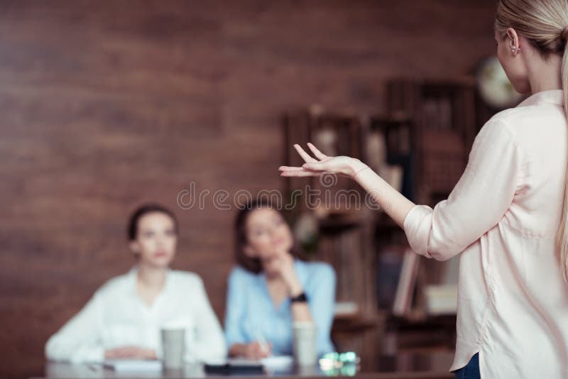 Businesswoman Gesturing and Telling Something To Colleagues Stock Photo ...