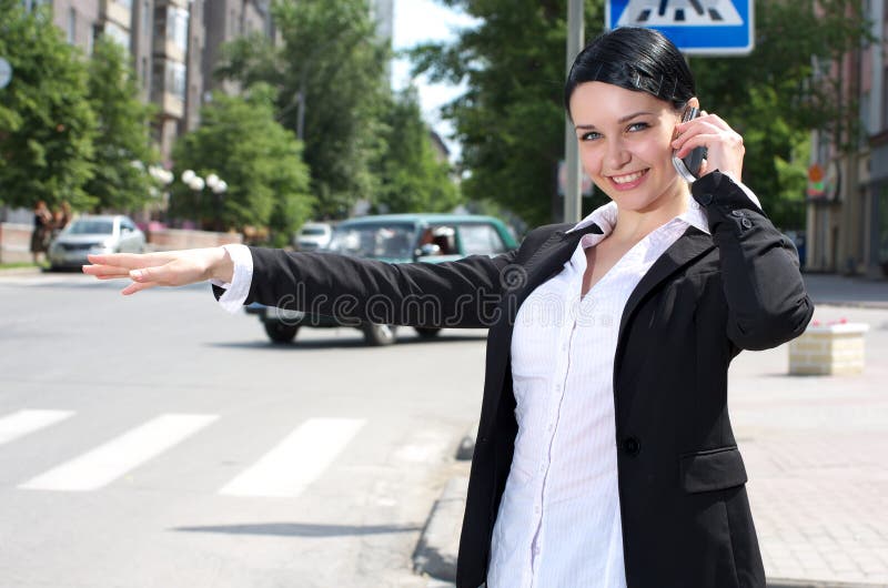 Businesswoman Hailing a Cab Stock Photo - Image of confidence, phone ...