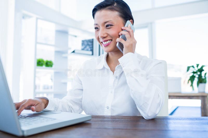 Businesswoman Having Phone Call and Using Laptop Computer Stock Image ...