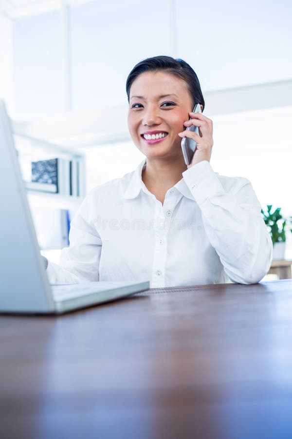 Businesswoman Having Phone Call and Using Laptop Computer Stock Photo ...