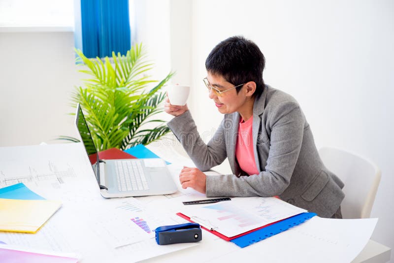 Businesswoman having tea stock photo. Image of computer - 97497328