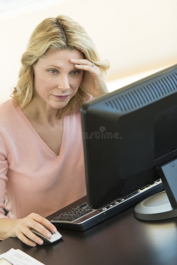 Businesswoman with Head in Hands Using Computer at Desk Stock Photo ...