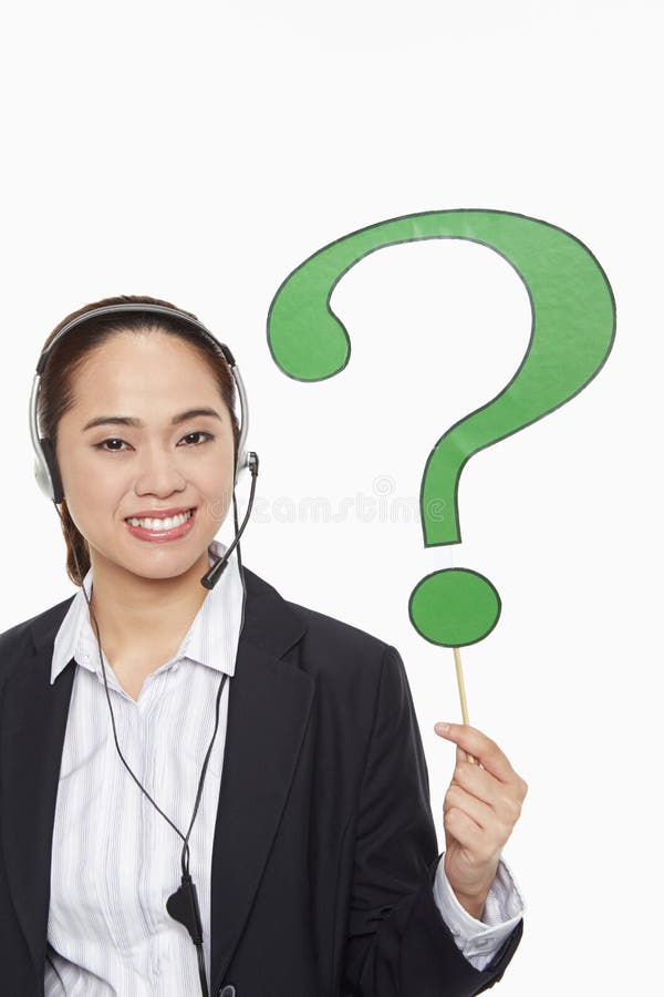 Businesswoman with Headset Holding Up a Question Mark Symbol Stock ...