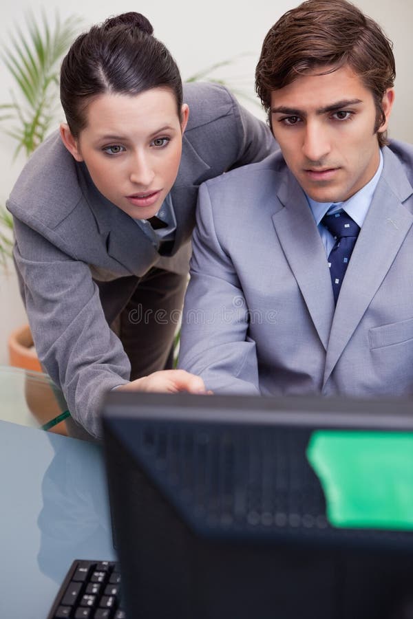 Businesswoman Helping Her Colleague with Computer Problems Stock Photo ...