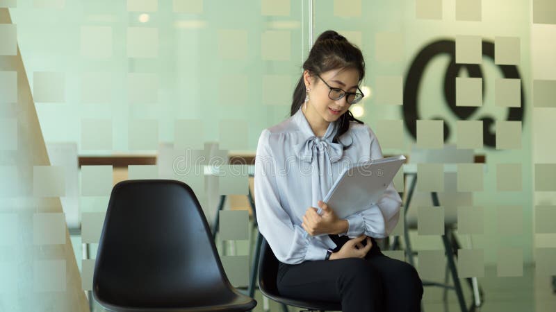 Businesswoman Holding Document File while Waiting for Interview Stock ...