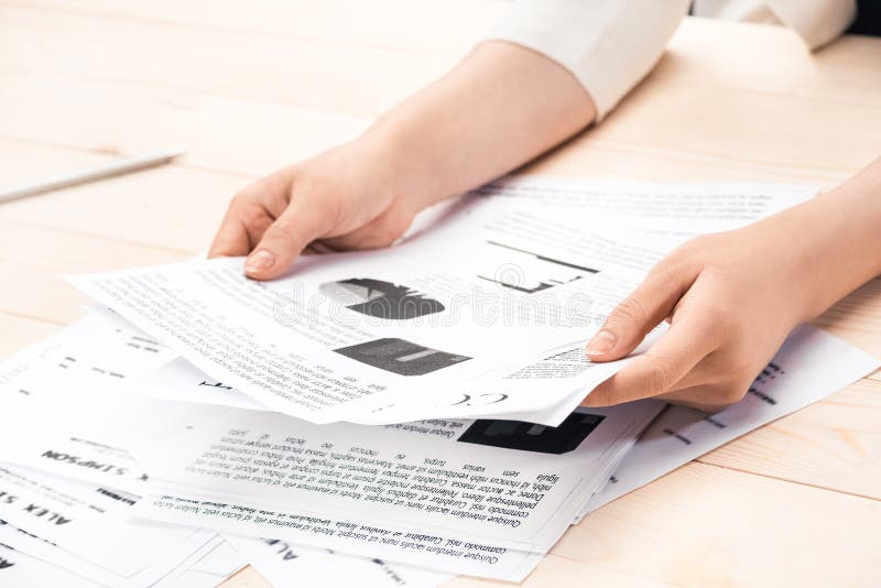 Businesswoman Holding Documents with Charts and Sitting at Table Stock ...
