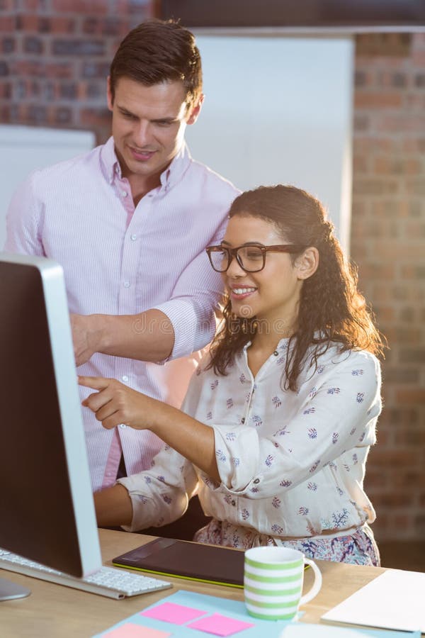 Businesswoman Interacting with Coworker while Working on Computer Stock ...