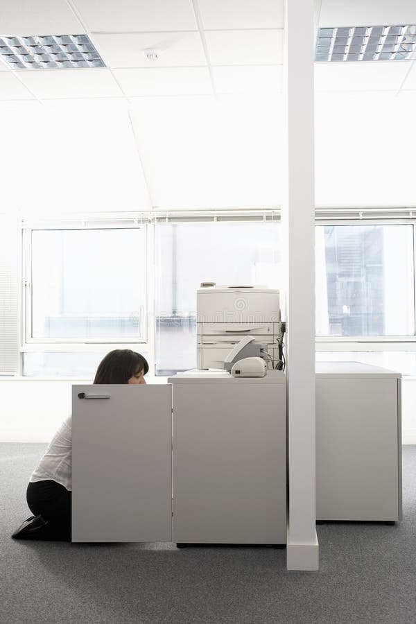 Businesswoman Kneeling in Front of Open Cabinet Stock Photo - Image of ...