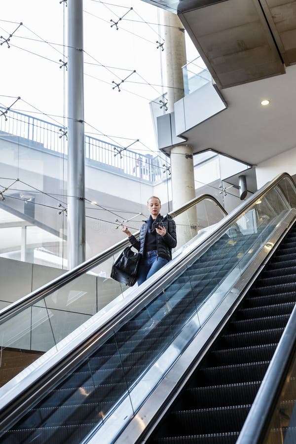 Businesswoman with Large Black Bag and Mobile Phone Descending on ... Businesswoman with Large Black Bag and Mobile Phone Descending on ...