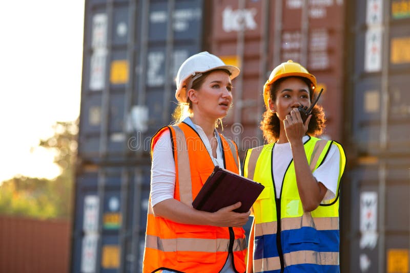 Businesswoman and Logistics Woman Worker Checking Containers Box and ...