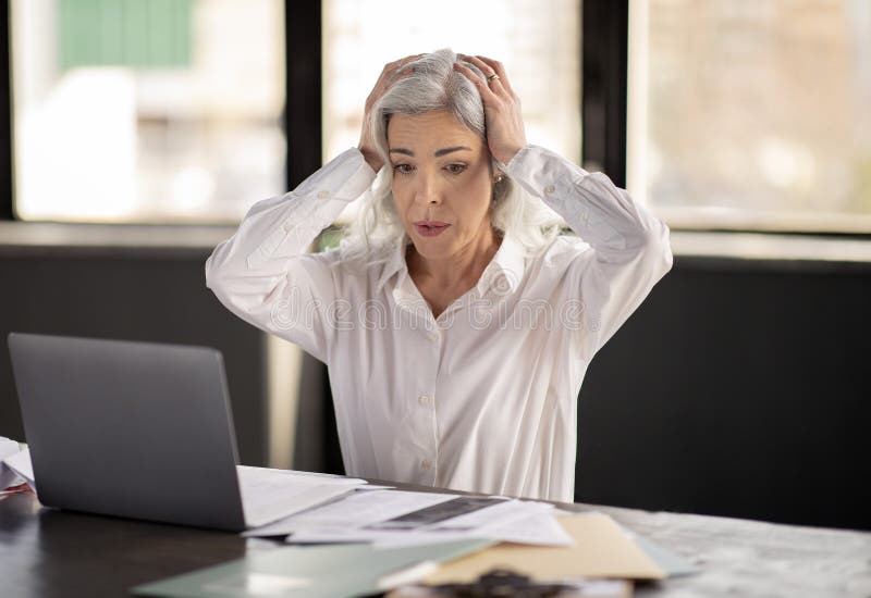 Businesswoman Looking at Laptop Touching Head Having Issue in Office ...