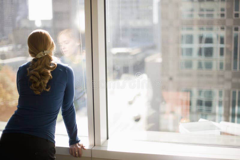 Businesswoman Looking Out Office Window Stock Photo - Image of ...
