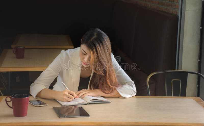 Businesswoman Makes a Note in Notebook. Stock Image - Image of ...