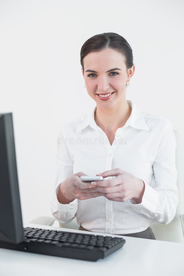 Businesswoman with Mobile Phone in Front of Computer Stock Image ...