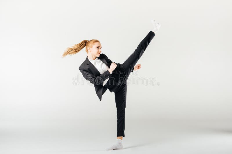 Businesswoman Performing Karate Kick in Suit and High Heels Stock Photo ...