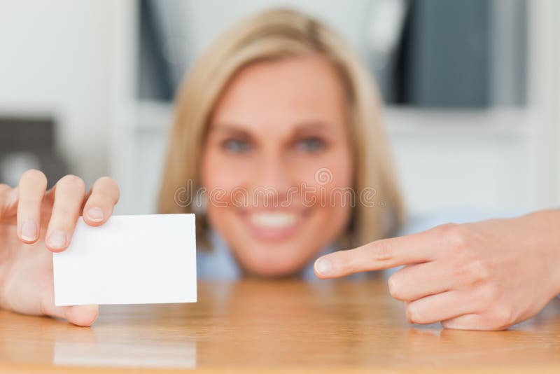 Businesswoman Pointing at a Card Crouching Stock Image - Image of close ...