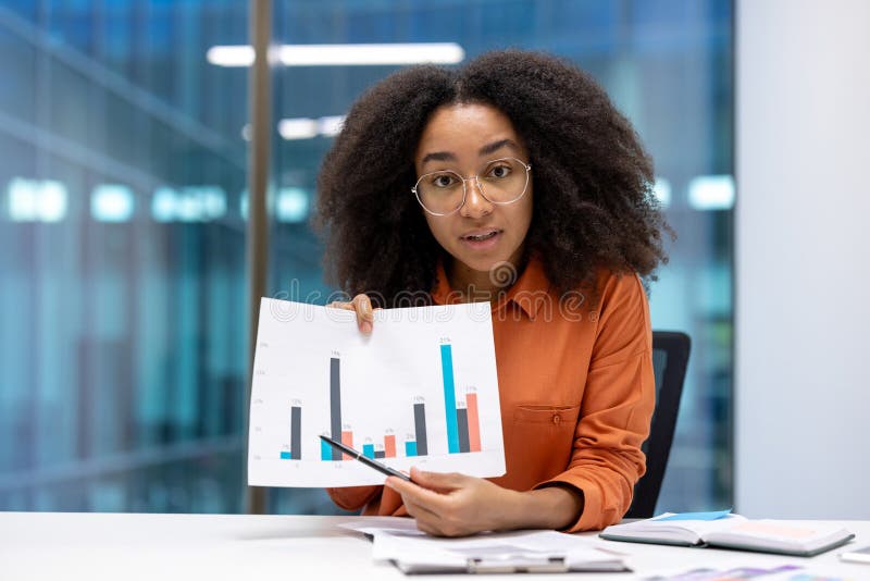 Businesswoman Presenting Statistical Data Analysis in a Modern Office ...