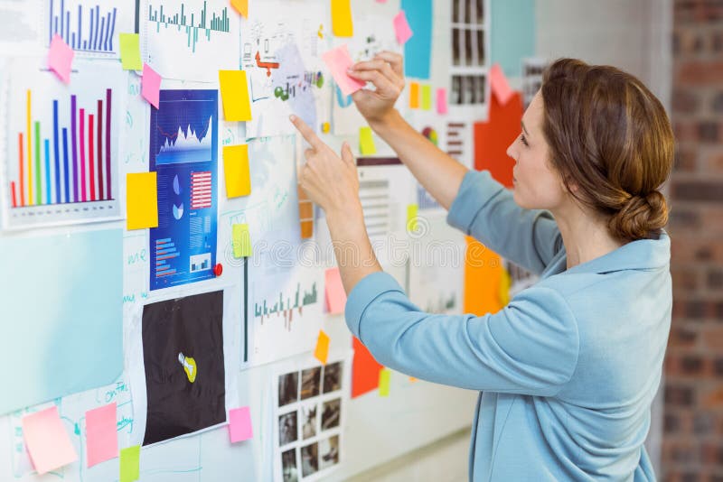 Businesswoman Putting Sticky Notes on Whiteboard Stock Photo - Image of ...