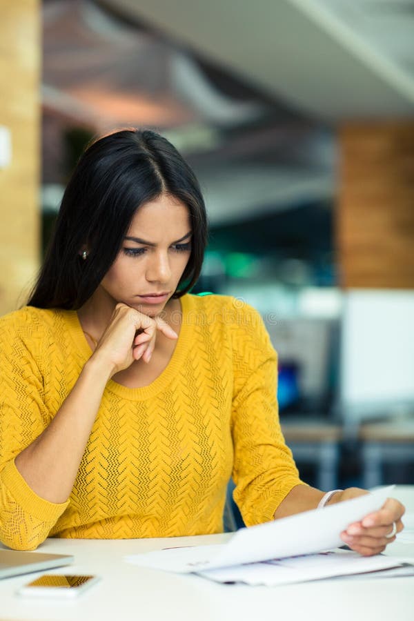 Businesswoman Reading Documents in Office Stock Photo - Image of inside ...