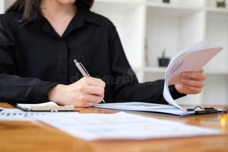 Businesswoman Signing on Document at Her Office Desk Stock Photo ...