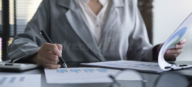 Businesswoman Signing on Document at Her Office Desk Stock Photo ...