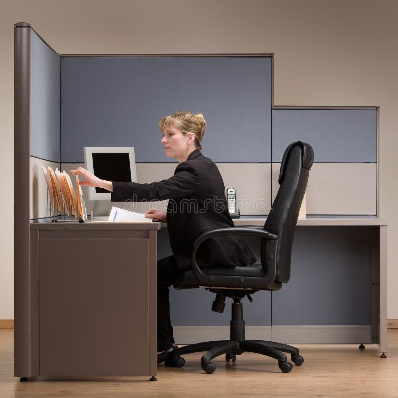 Businesswoman Sitting at Desk in Cubicle Stock Image - Image of seated ...