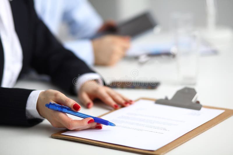 Businesswoman Sitting in Office, Writing on Documents Stock Image ...
