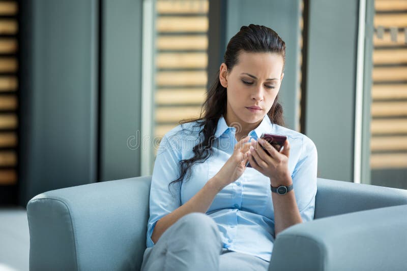 Businesswoman Sitting and Using a Mobile Phone Stock Photo - Image of ...