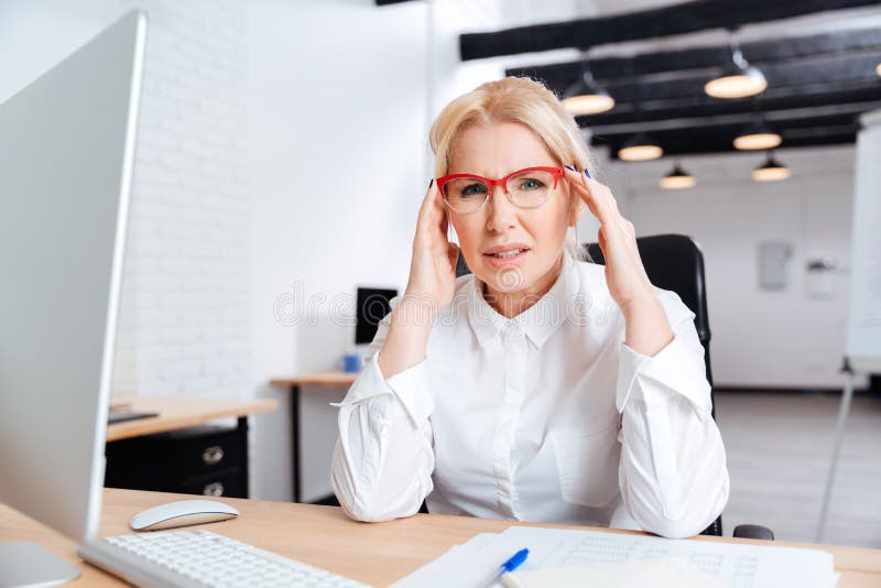 Businesswoman Sitting at Workplace and Thinking about Work in Office ...