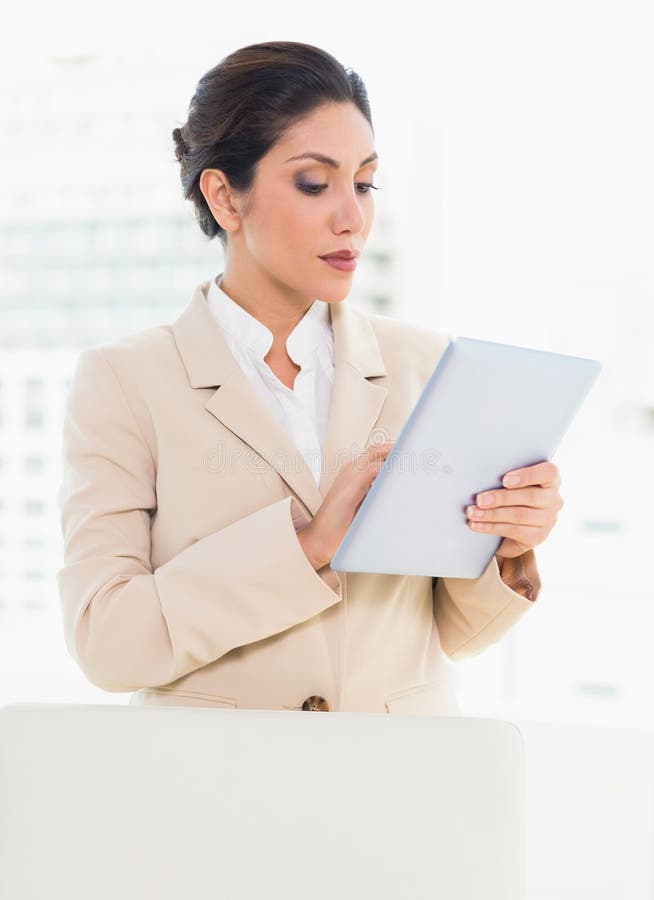 Businesswoman Standing Behind Her Chair Using Digital Tablet Stock ...