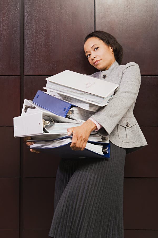 Businesswoman Struggling with Heavy Files Stock Photo - Image of ...