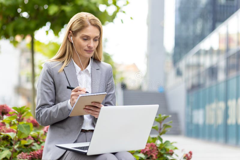 Businesswoman Taking Notes Working Laptop Outdoors Modern Urban Setting ...
