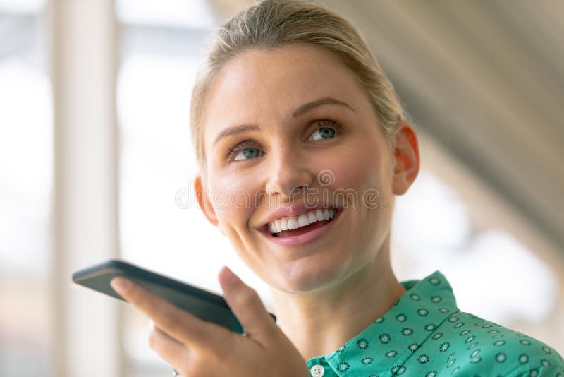 Businesswoman Talking on Mobile Phone in Office Stock Photo - Image of ...