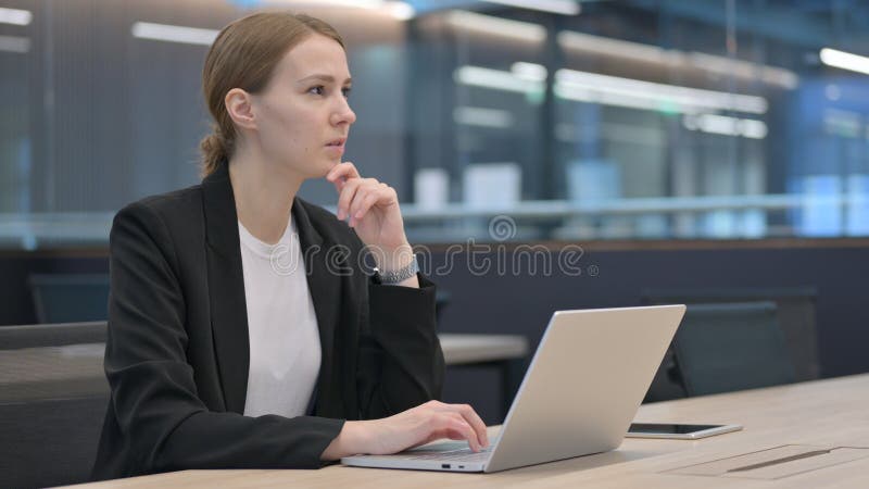 Businesswoman Thinking while Using Laptop at Work Stock Image - Image ...