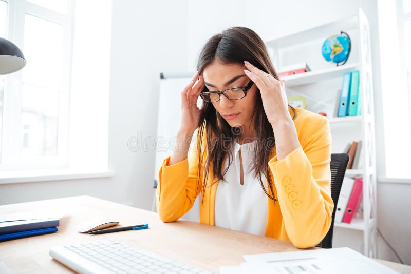 Businesswoman Thinking about Work in Office Stock Photo - Image of ...