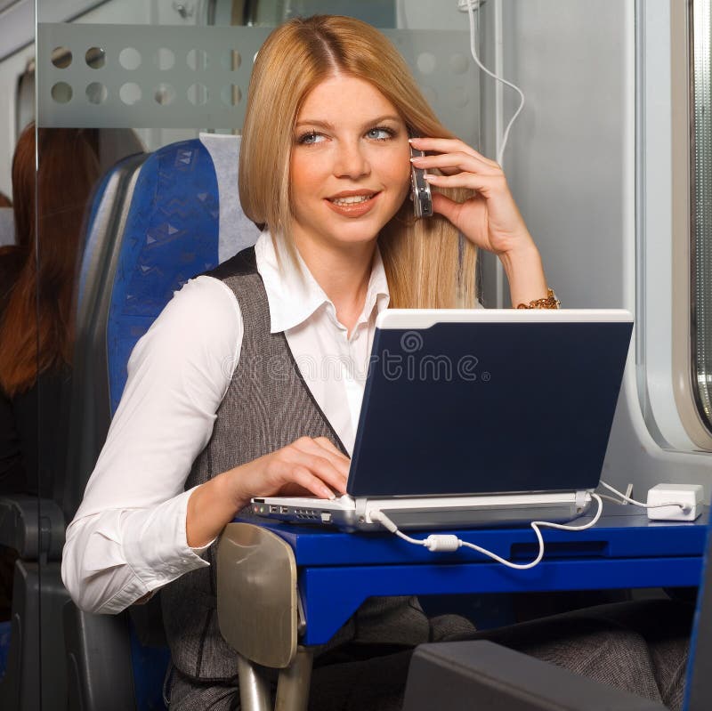 Businesswoman Commuting To Work on Train and Using Laptop Stock Image ...