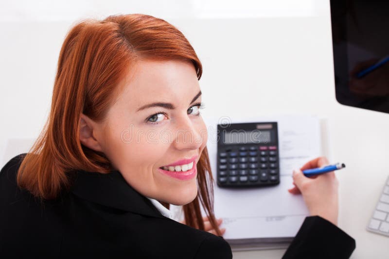 Businesswoman Using Calculator at Office Desk Stock Photo - Image of ...