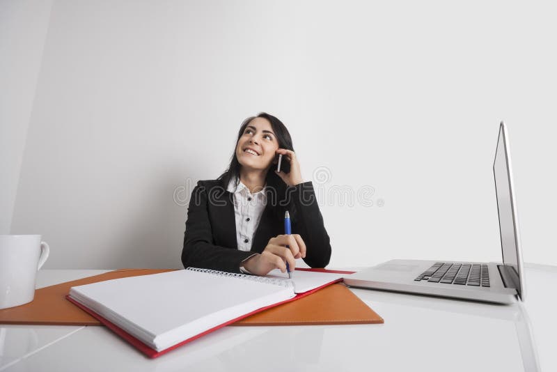 Businesswoman Using Cell Phone at Office Desk Stock Image - Image of ...
