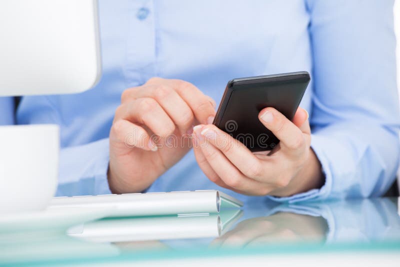 Businesswoman Using Cellphone Sitting in Front of Computer Stock Image ...