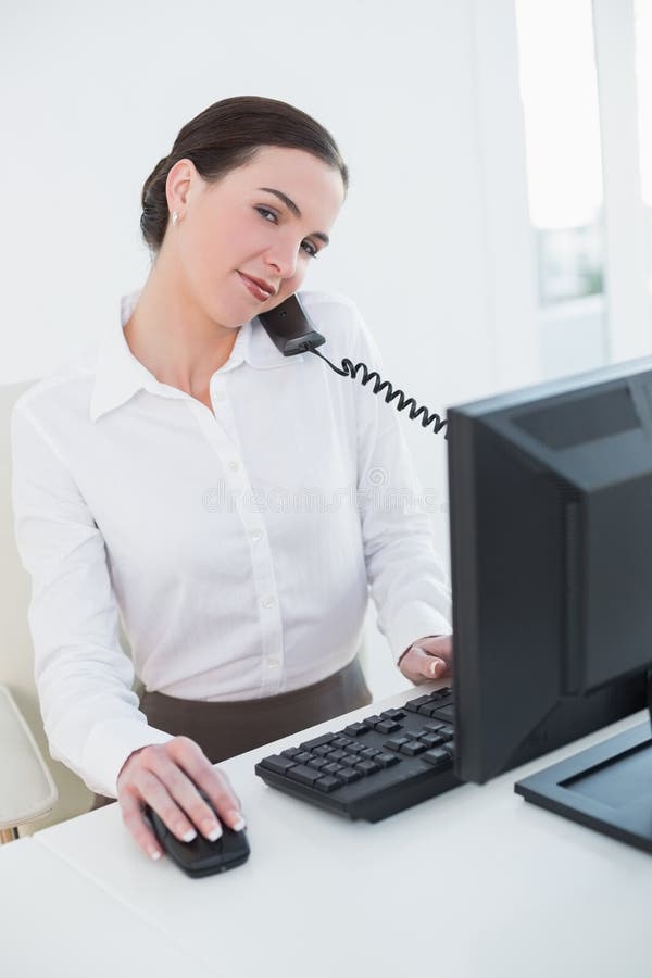 Businesswoman Using Computer and Telephone in Office Stock Image ...