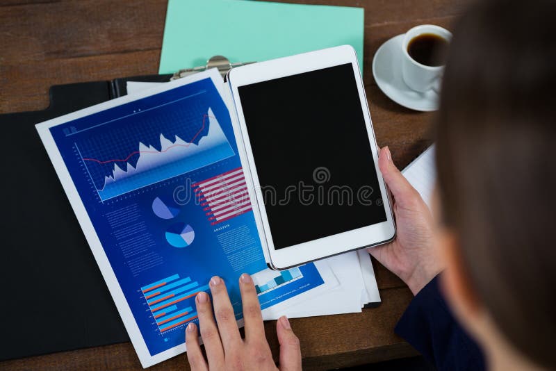 Businesswoman Using Digital Tablet with Graph Chart on Table Stock ...