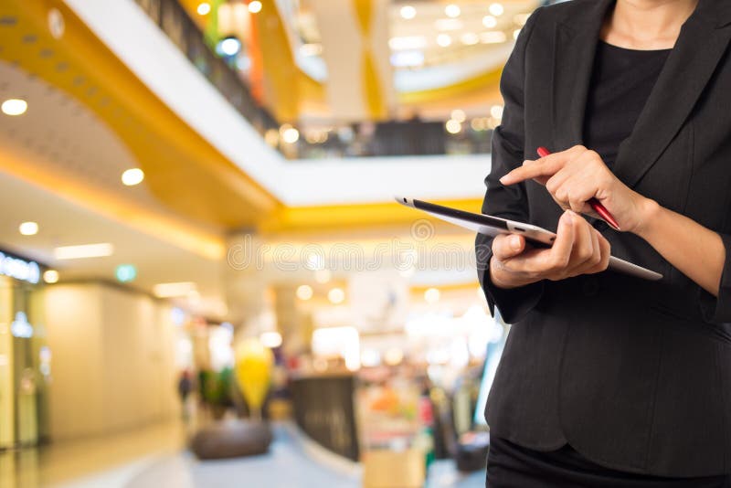 Businesswoman Using Digital Tablet in the Shopping Mall. Stock Image ...